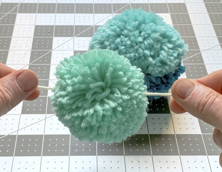 Make a Pom Pom Garland in Three Easy Steps! - DIY Candy